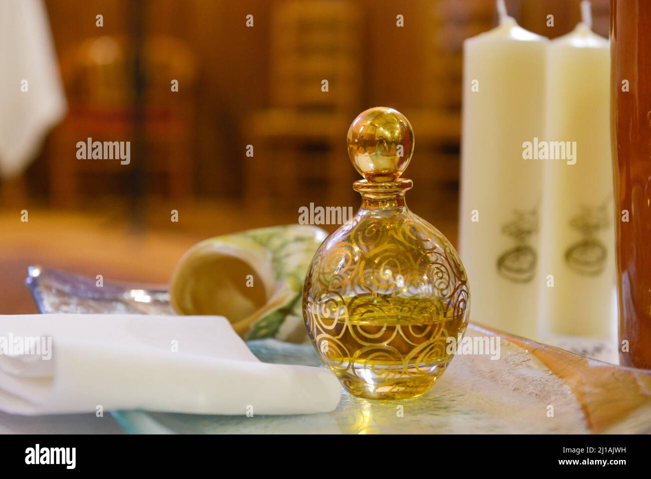Close-up of a glass bottle containing oil before a baptism ceremony in ...
