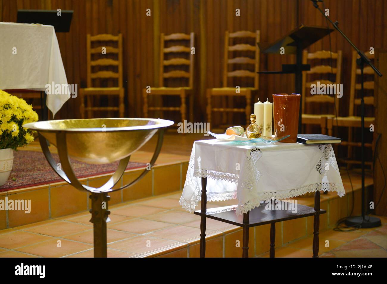 Items prepared on a table for the ceremony of a baptism in a church ...