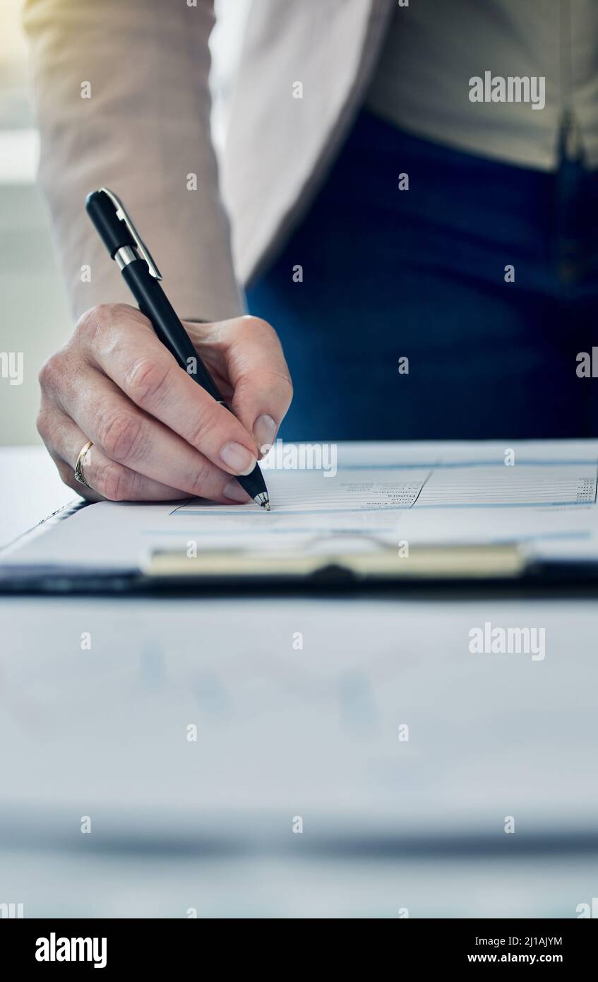 Signing the deal of the century. Shot of an anonymous businessperson ...