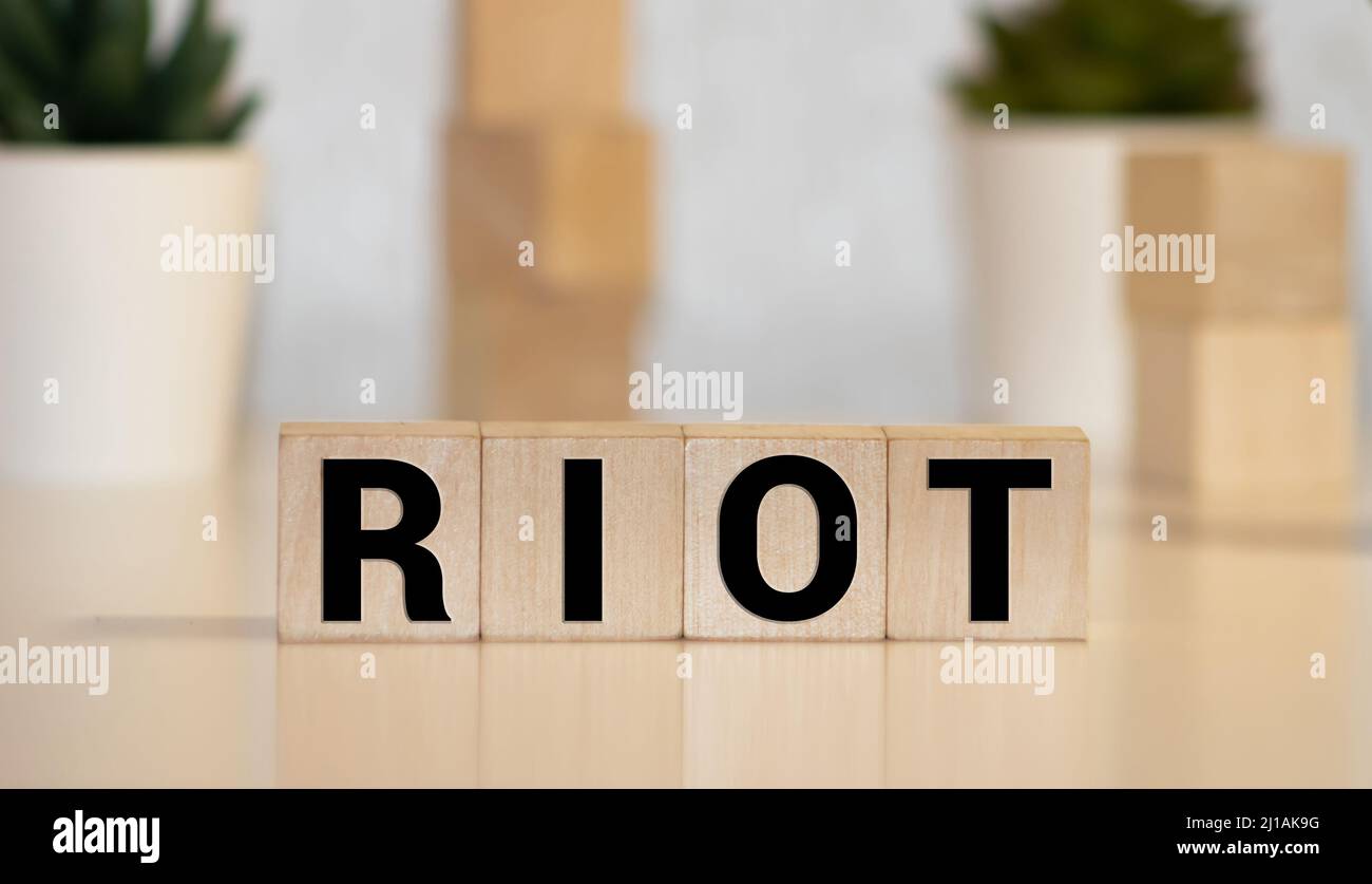 Riot - word from wooden blocks with letters, noisy and violent public ...