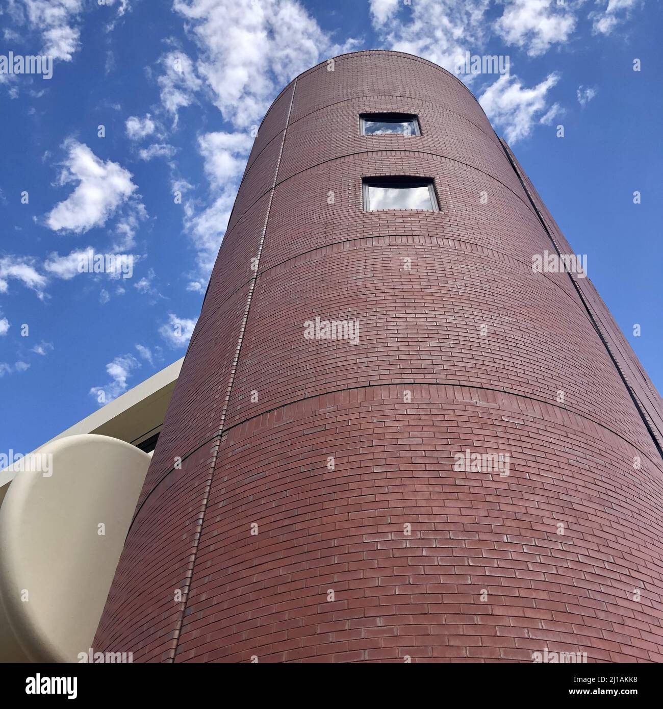 tall round red brick chimney shape building looking up from below blue ...