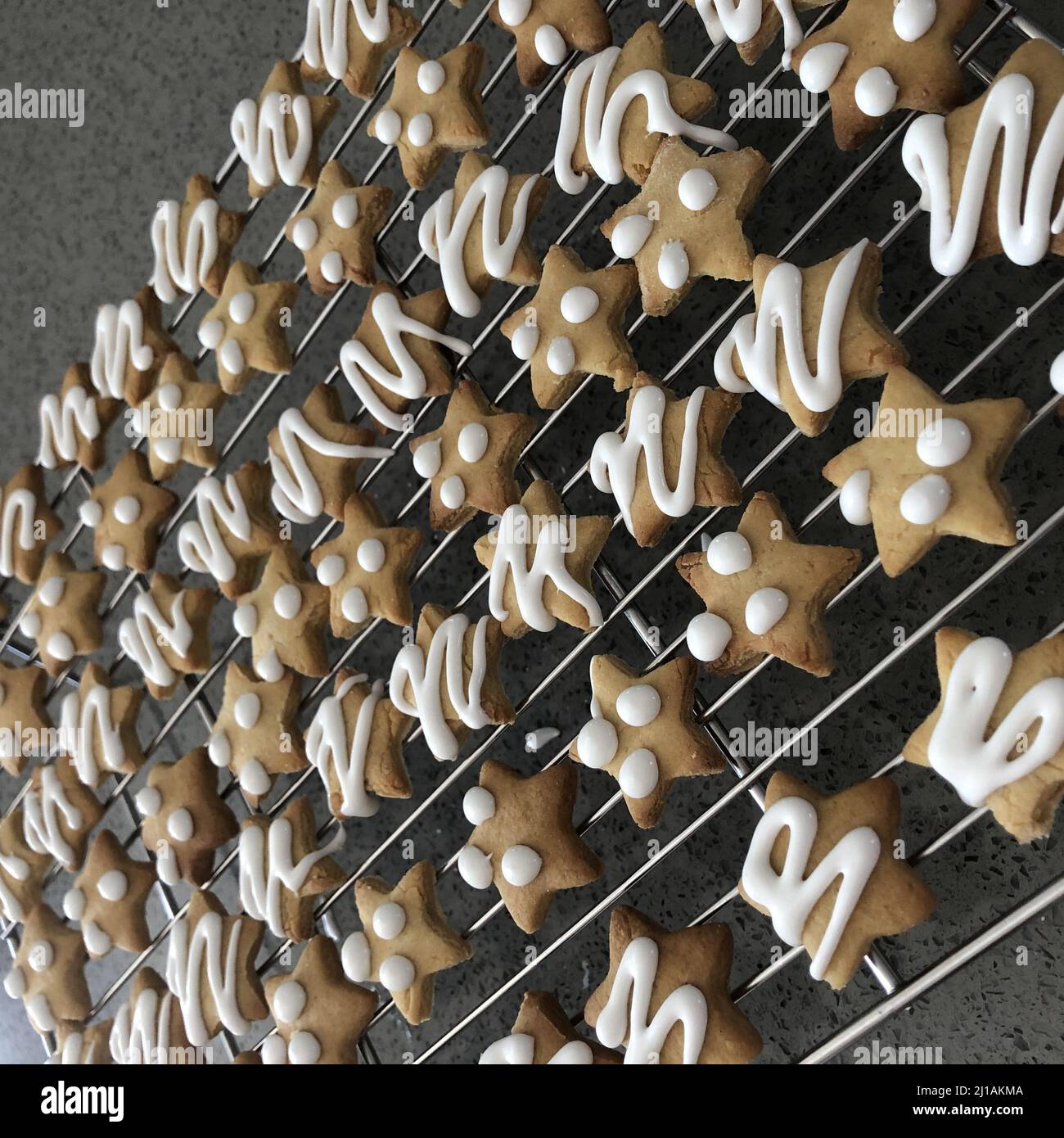 freshly baked and iced star shaped cookies on a cooling rack decorated ...