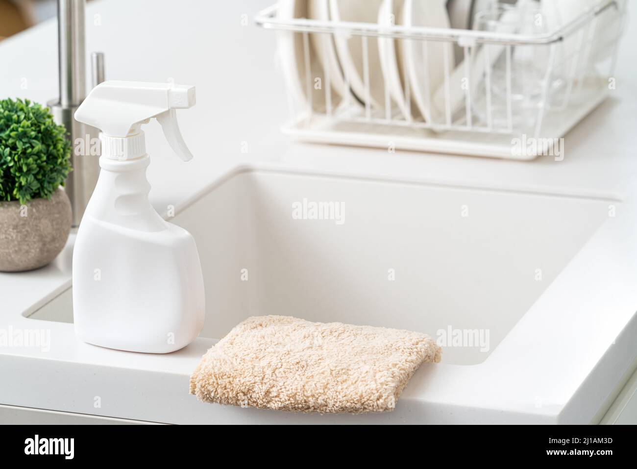 Concept of cleaning product spray bottle and rag in modern kitchen ...
