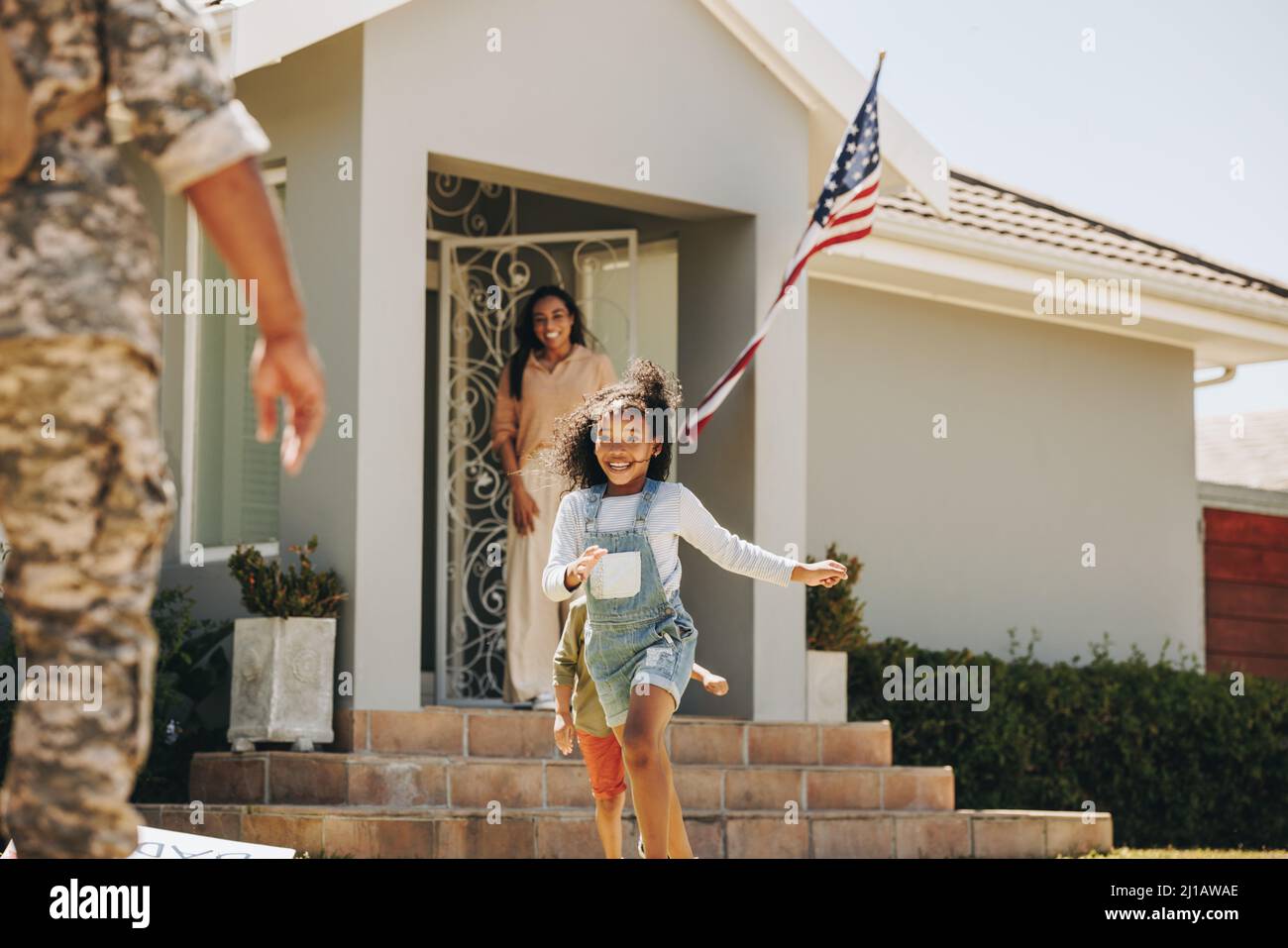 Happy young children running to welcome their father upon his return ...