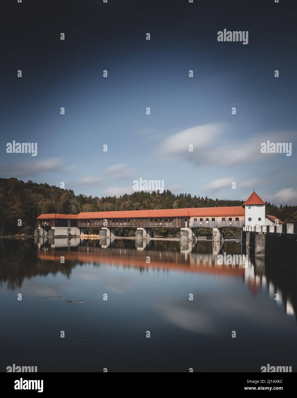 A vertical shot of the weir Ickinger Wehr located in Germany reflecting ...