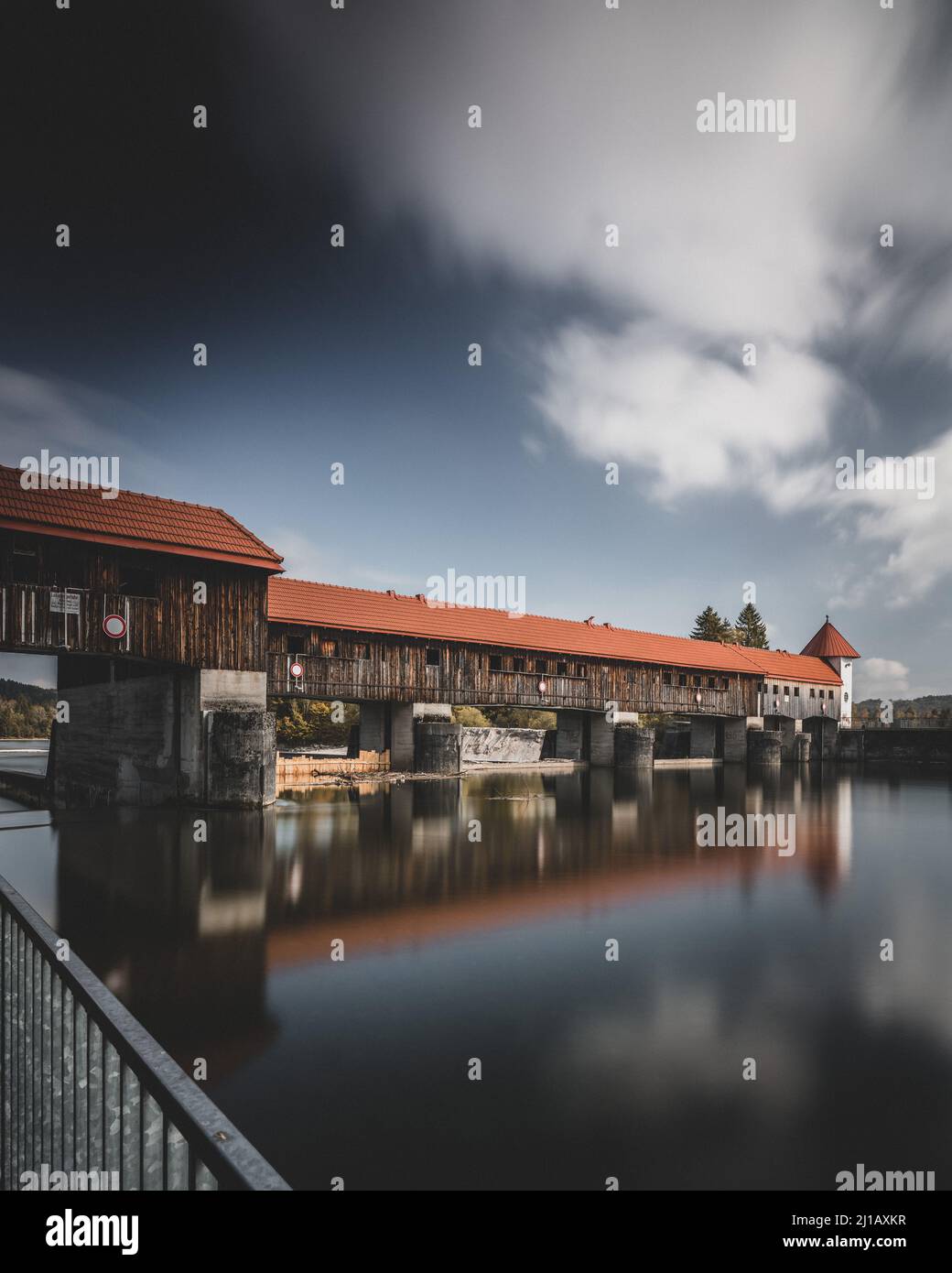 A vertical shot of the weir Ickinger Wehr located in Germany reflecting ...