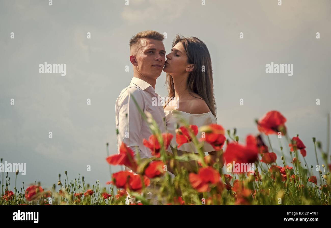Happy couple in love kissing in beautiful field of poppy flower on ...