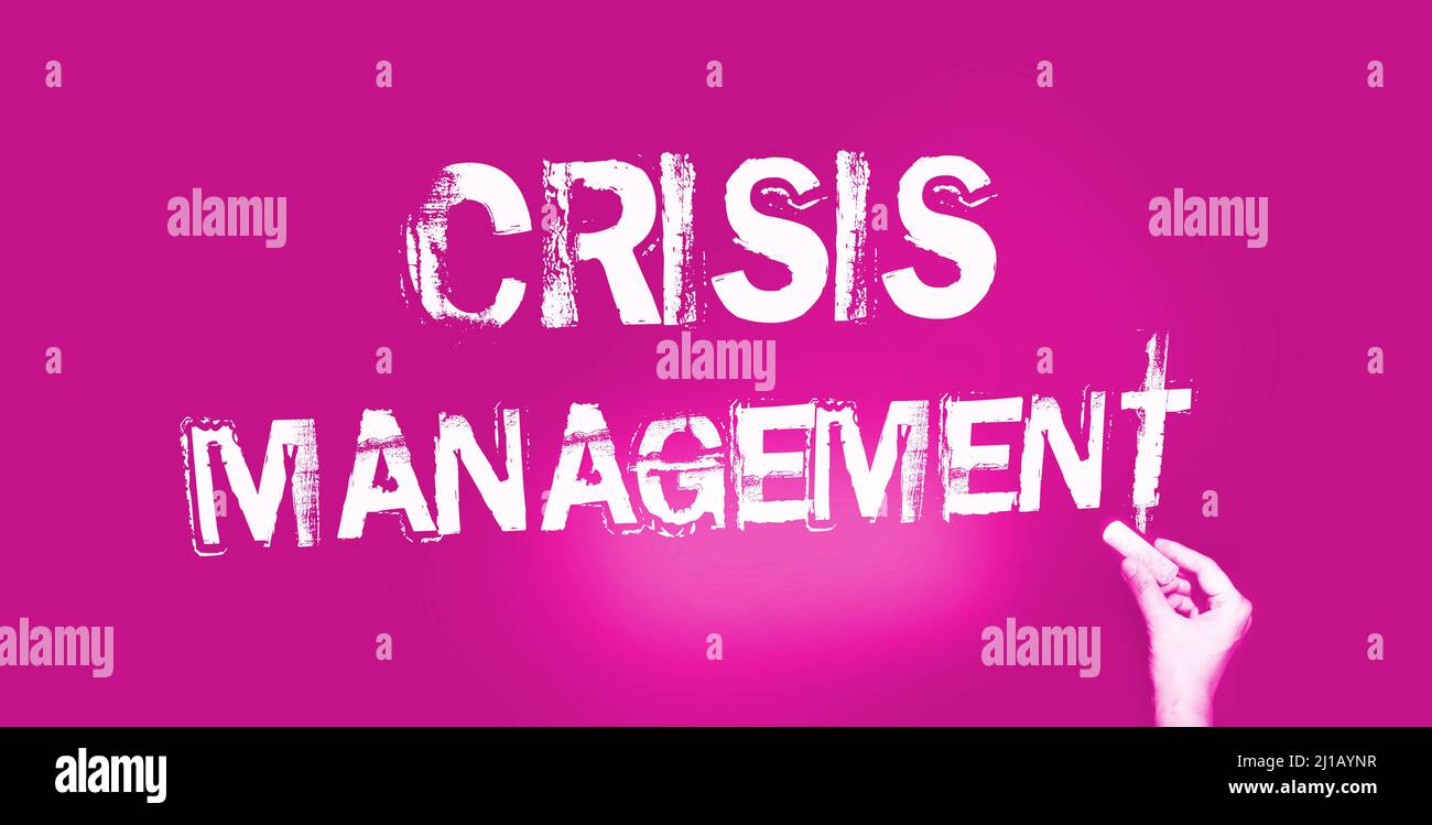 Crisis Management word on a black chalk Board, hand with chalk. Pale ...