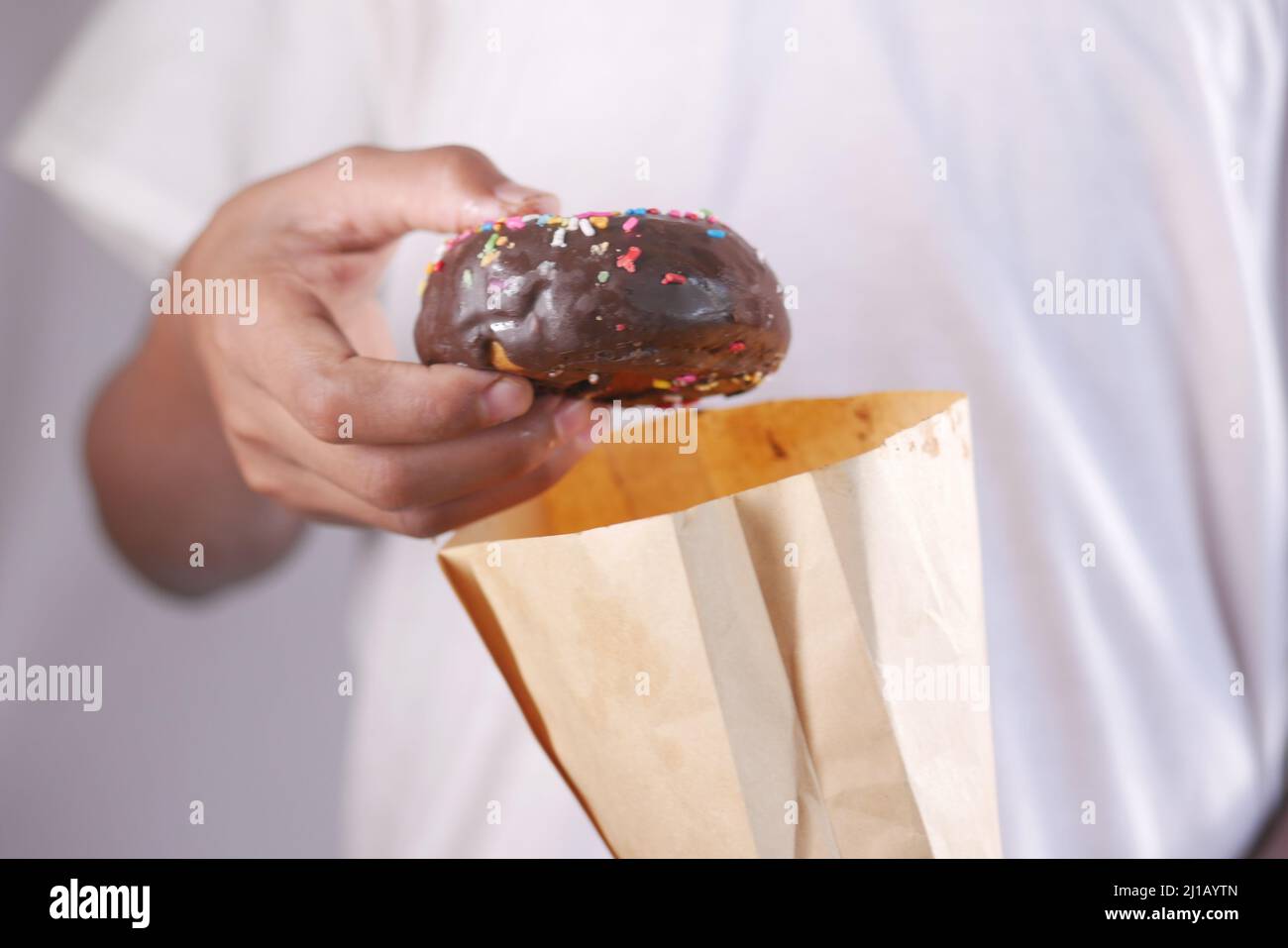 Hand holding donuts hi-res stock photography and images - Alamy