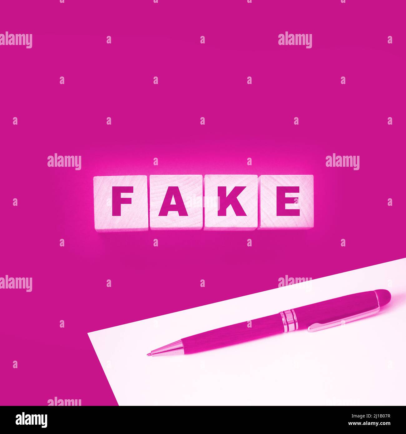 FAKE word written in wooden blocks on black background Stock Photo - Alamy