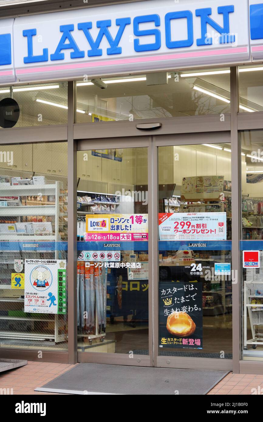 A Lawson convenience store sign in front of a store in Tokyo's ...