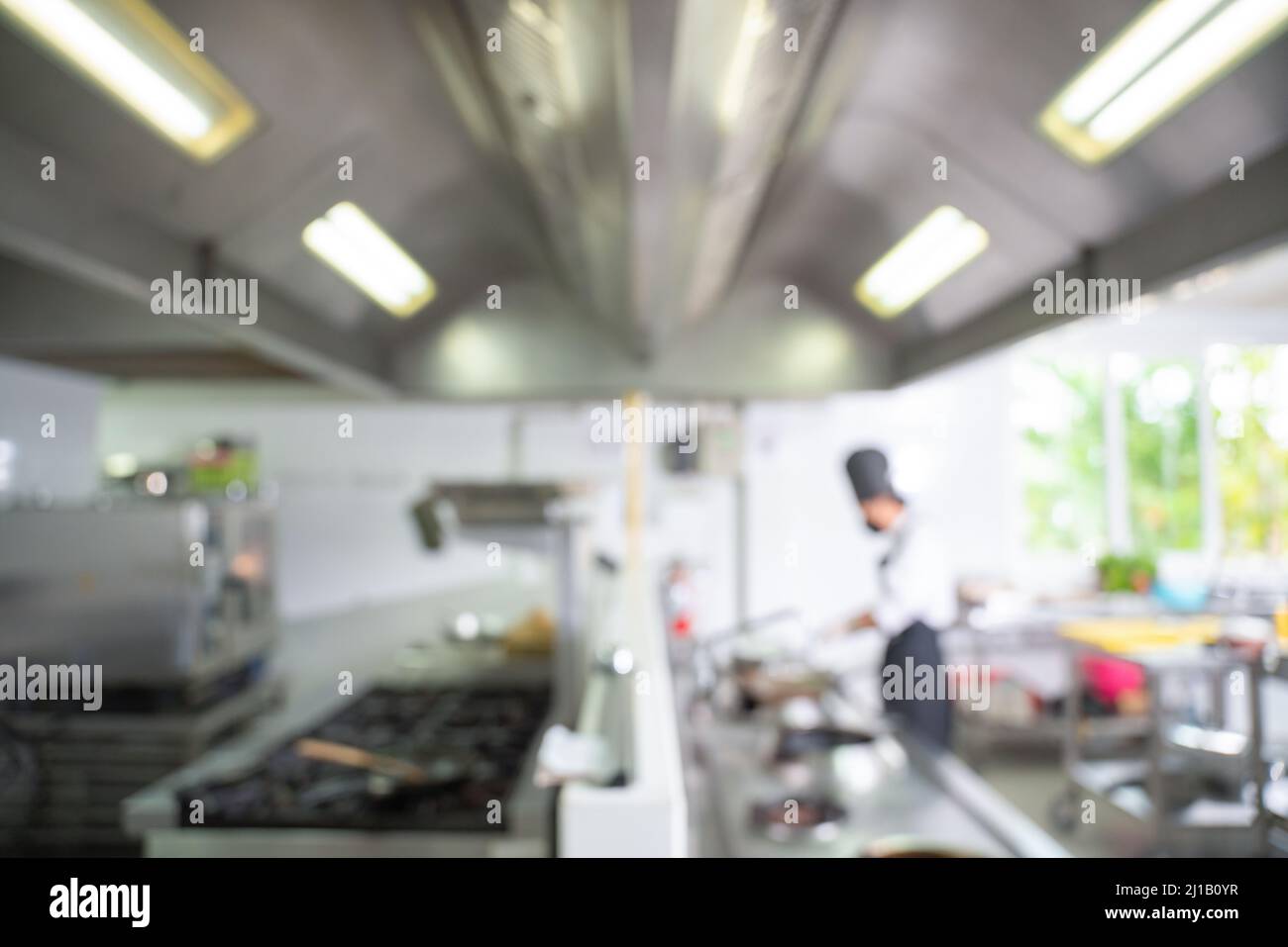 Blurred of Chef in hotel or restaurant kitchen cooking at restaurant ...