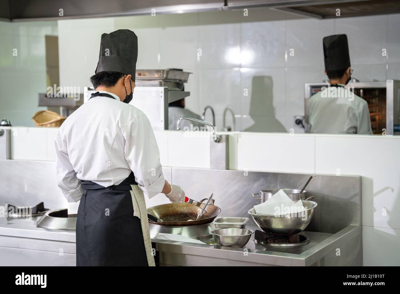Two chefs prepare meals in the restaurant's kitchen. Modern kitchen ...