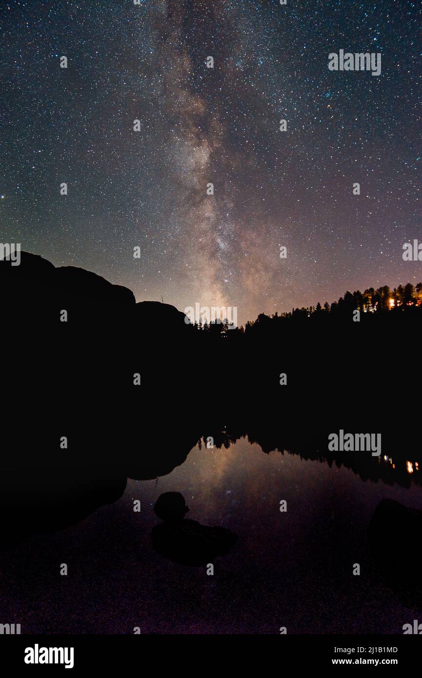A vertical shot of the Milky Way starry sky over the Sylvan Lake, South ...