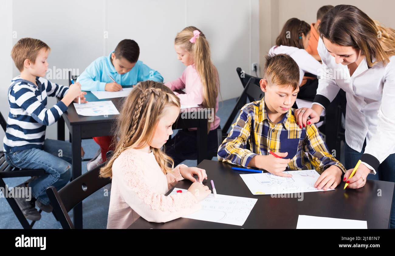 Children of elementary age having class of art Stock Photo - Alamy