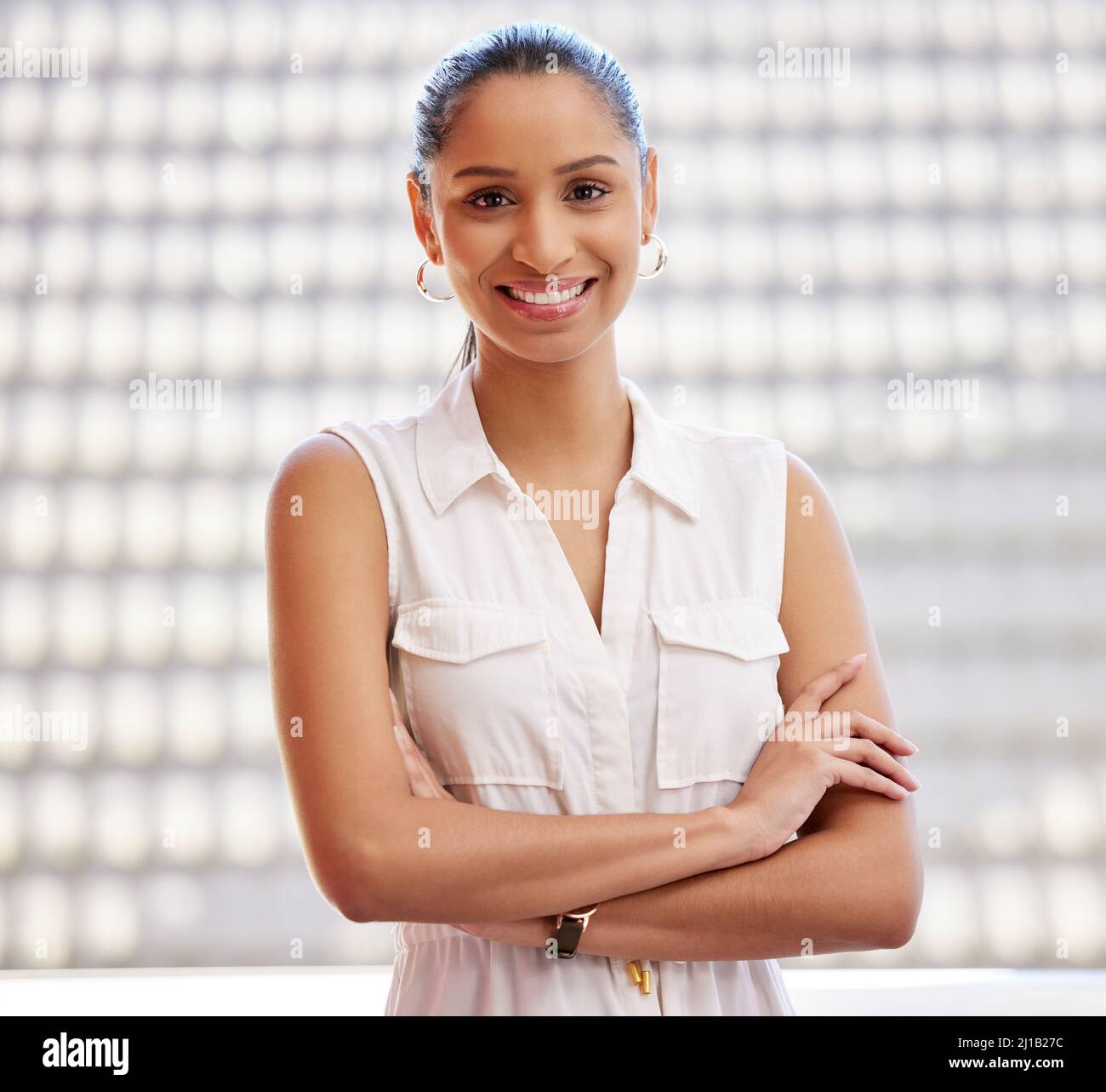 Proud of her business. shot of a young businesswoman standing in an ...