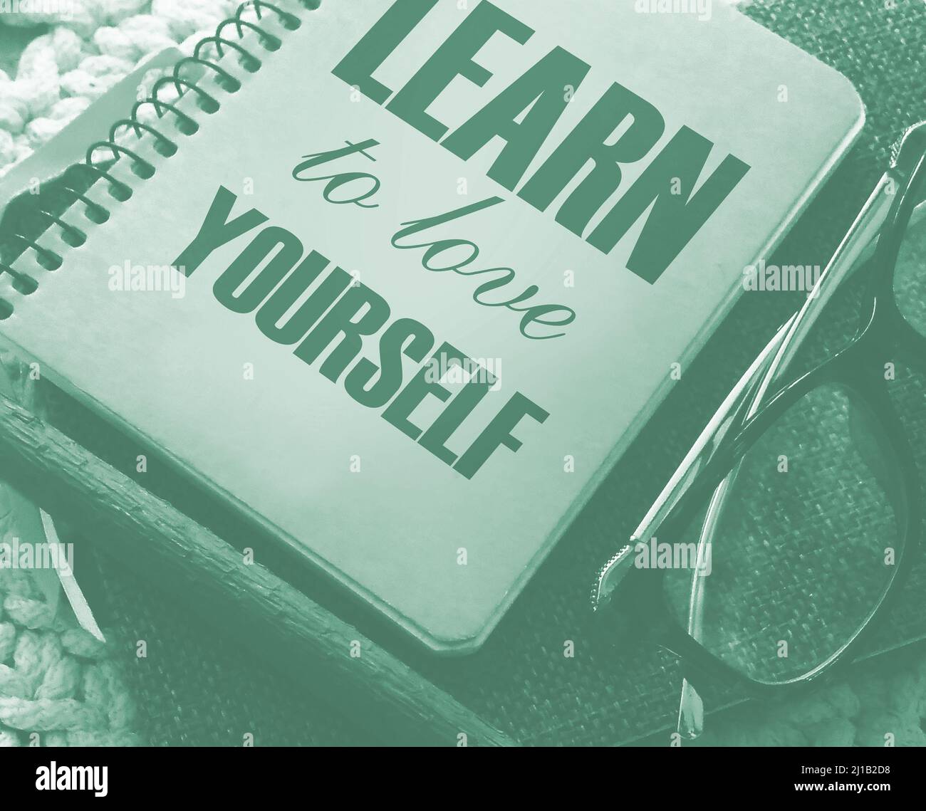 Learn to love yourself words on a notebook with glasses and pen ...