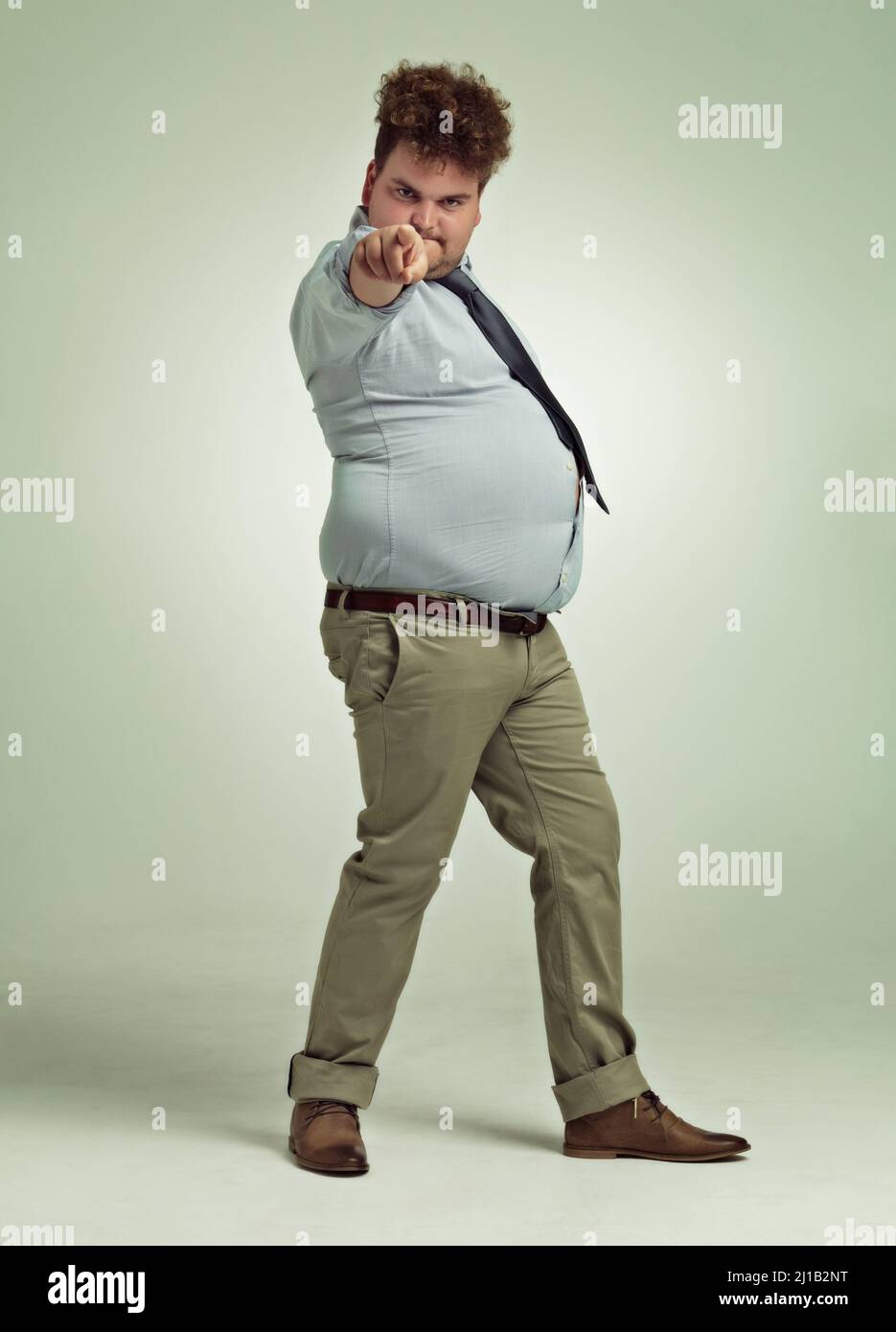 You Light up my life.... Full length shot of an overweight man pointing ...