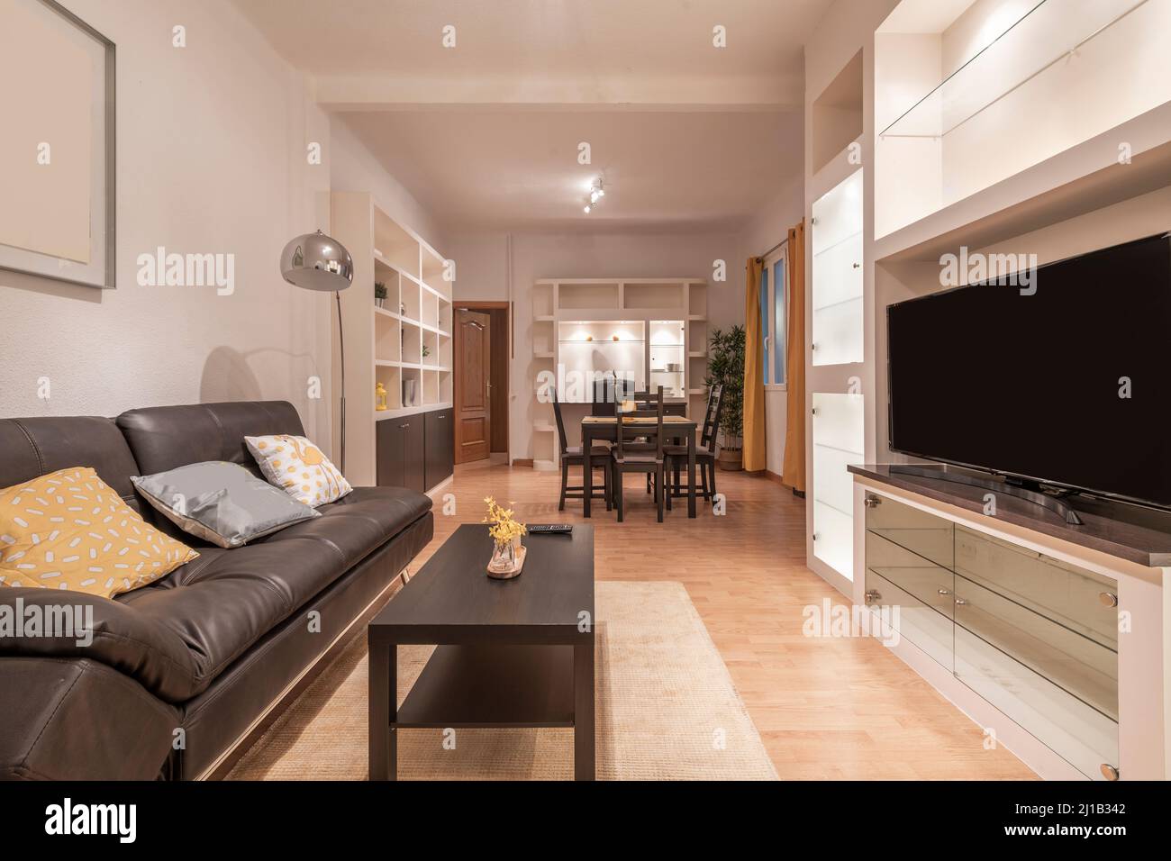 living room with leather sofa with matching coffee table and white ...
