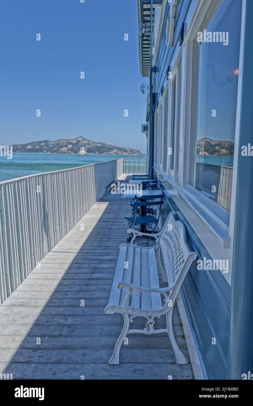 A vertical shot of a bench beside restaurant with a view of Richardson ...