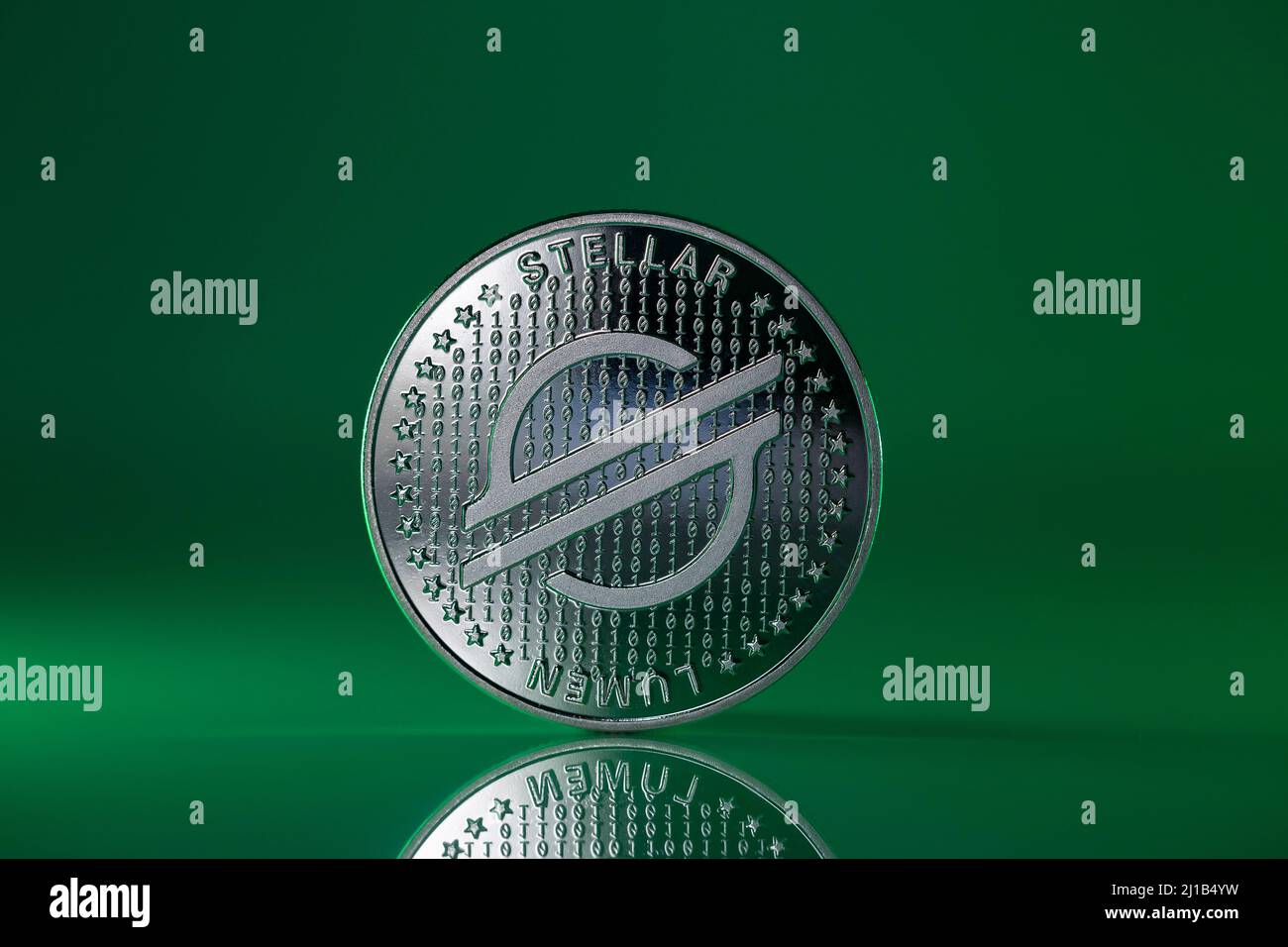 Stellar XLM Cryptocurrency physical coin placed on reflective surface ...