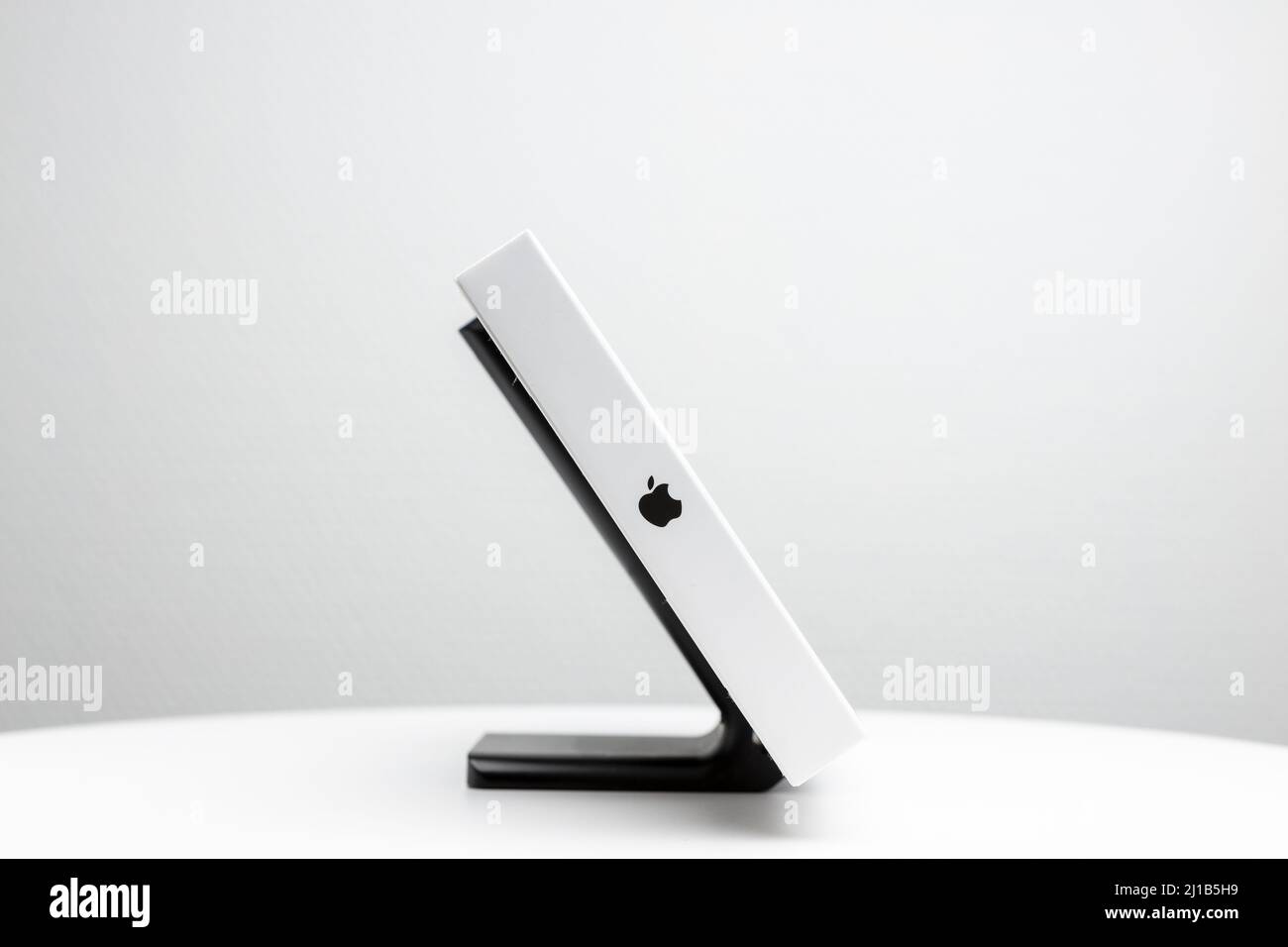 Black display stand with Apple logo showing on the side white package ...