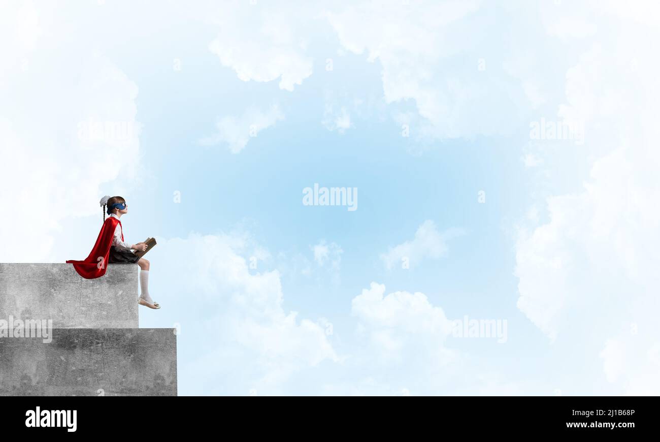 Girl power concept with cute kid guardian against cloudscape background ...