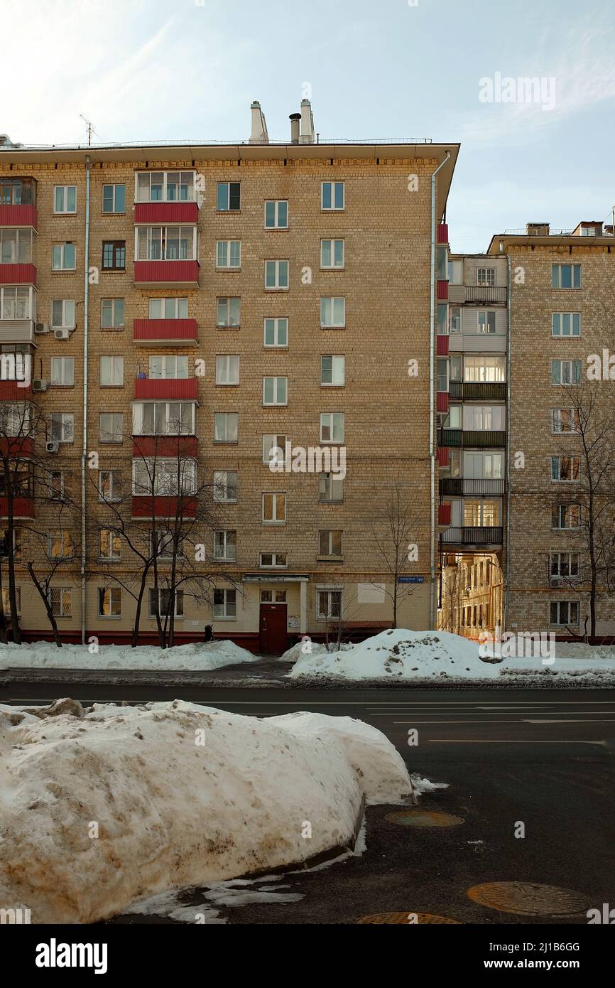 Russian panel house and windows of different apartments with red ...