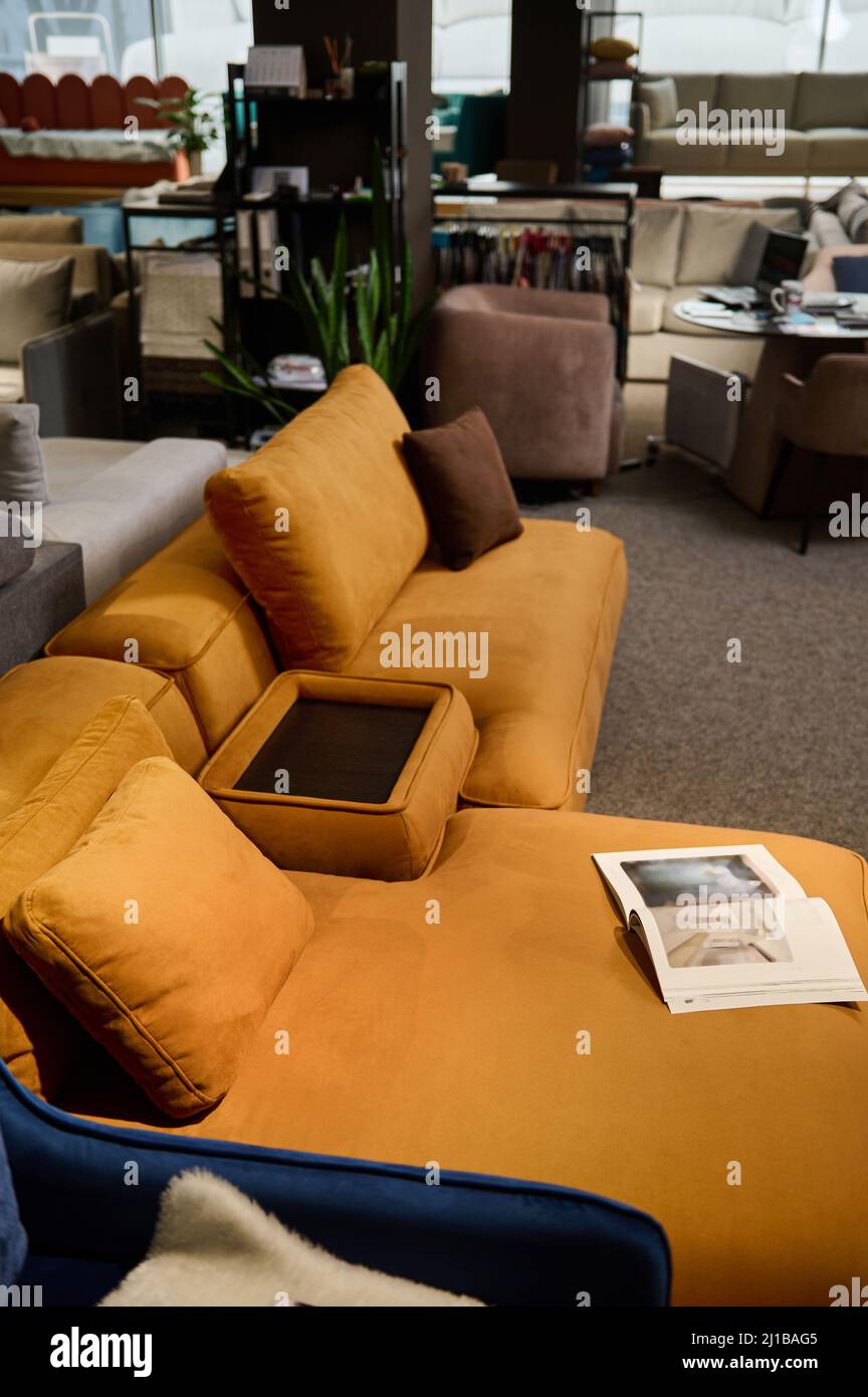 Bright orange couch with a catalogue exhibited for sale in the ...