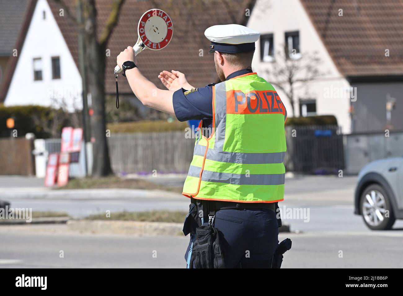 A traffic cop raises a trowel (STOP POLICE) and waves a car driver to ...