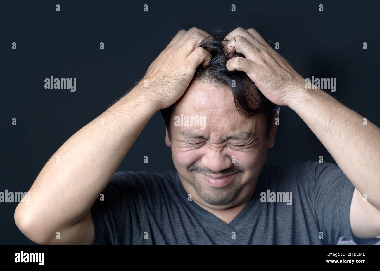 Middle age man has itching in his hair on black background, Hair care ...