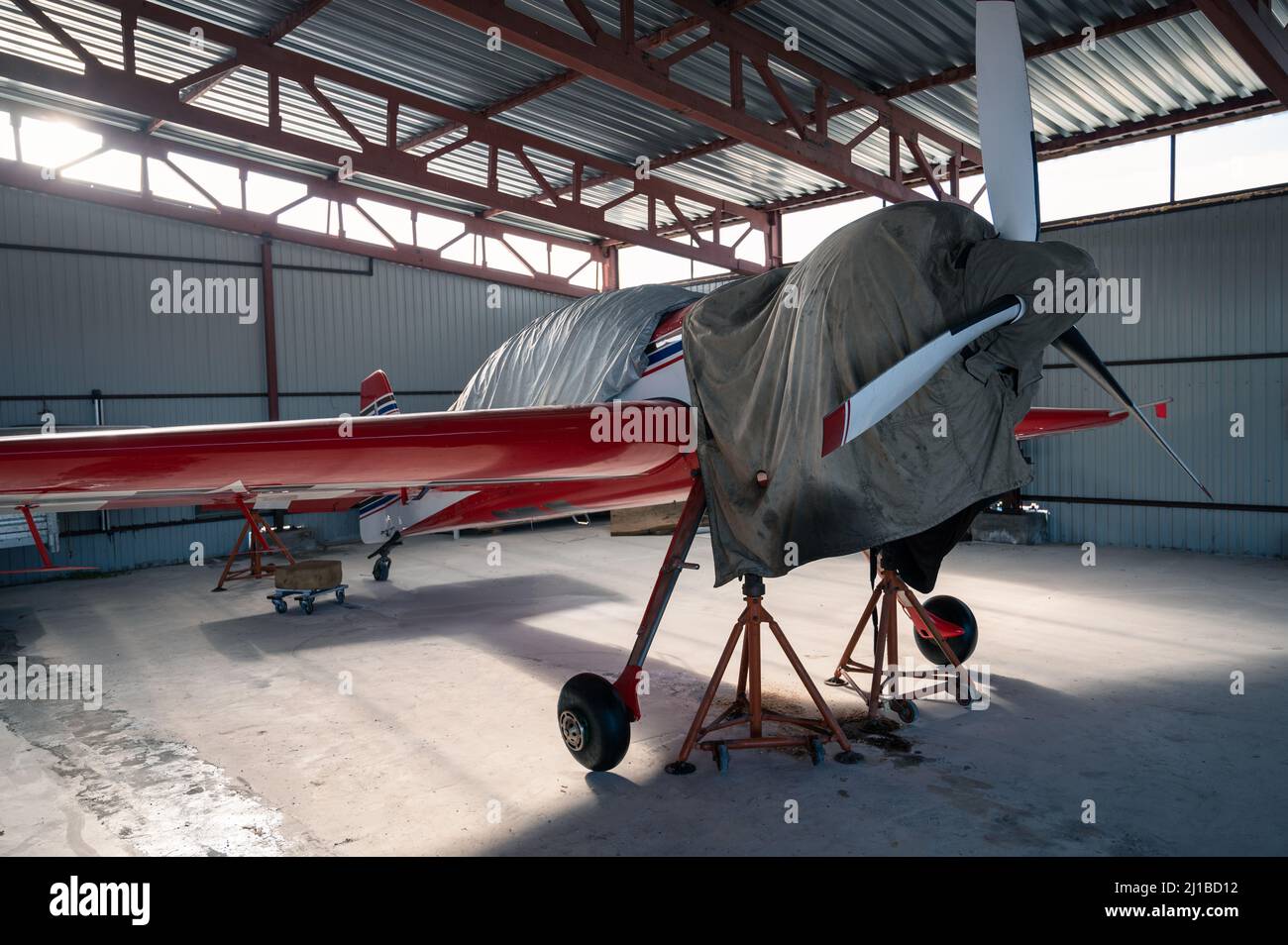 Small private lightweight propeller airplanes in hangar Stock Photo - Alamy
