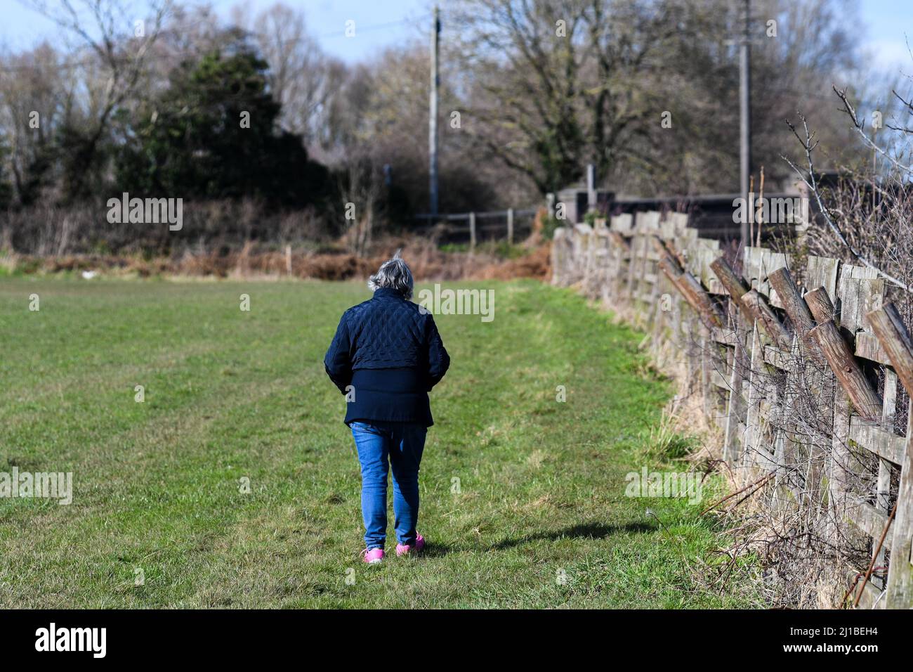 Woman walking in the field hi-res stock photography and images - Alamy
