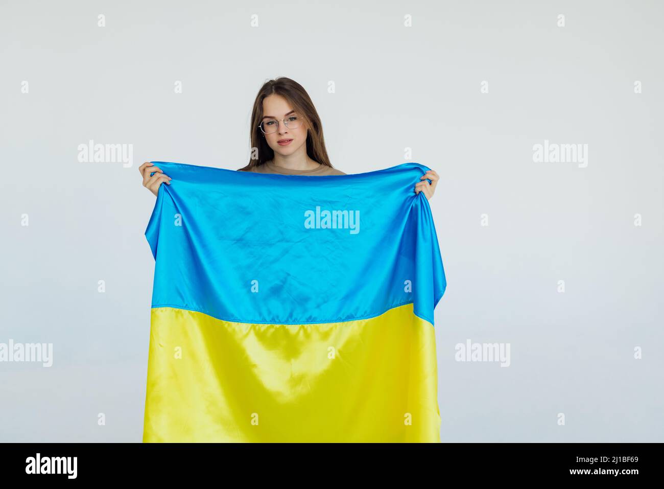 Beautiful young woman with flag of Ukraine on white background Stock ...