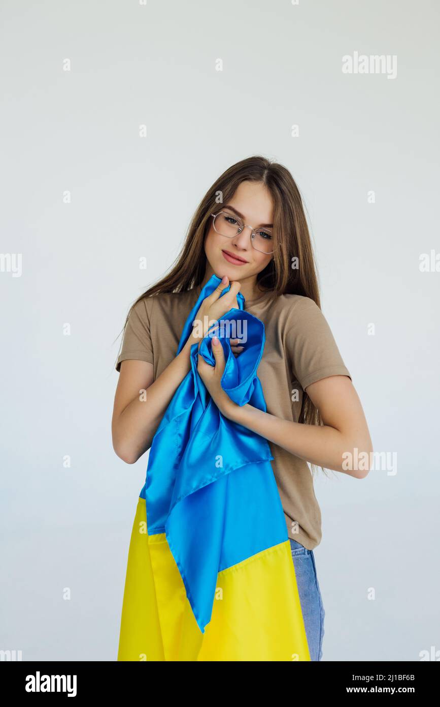 Young pretty woman hug Ukraine national flag isolated on white ...