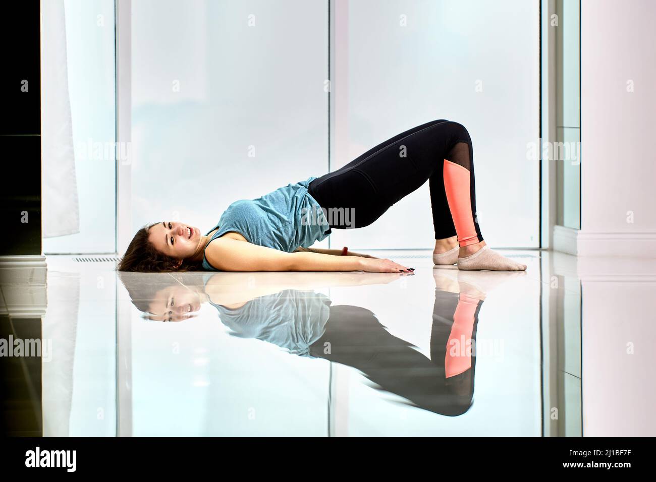 Underfloor heating with woman who is training inside near window Stock ...