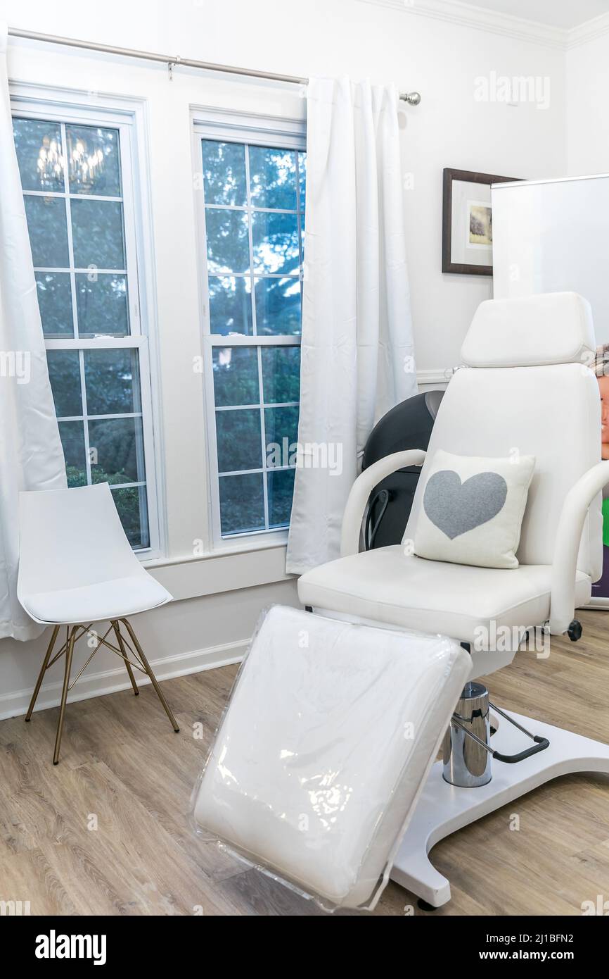 A medical spa patient room that is empty with a heart pillow on the ...