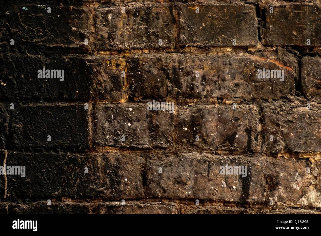dark, dirty burnt wall, old brick, next to the stove Stock Photo - Alamy