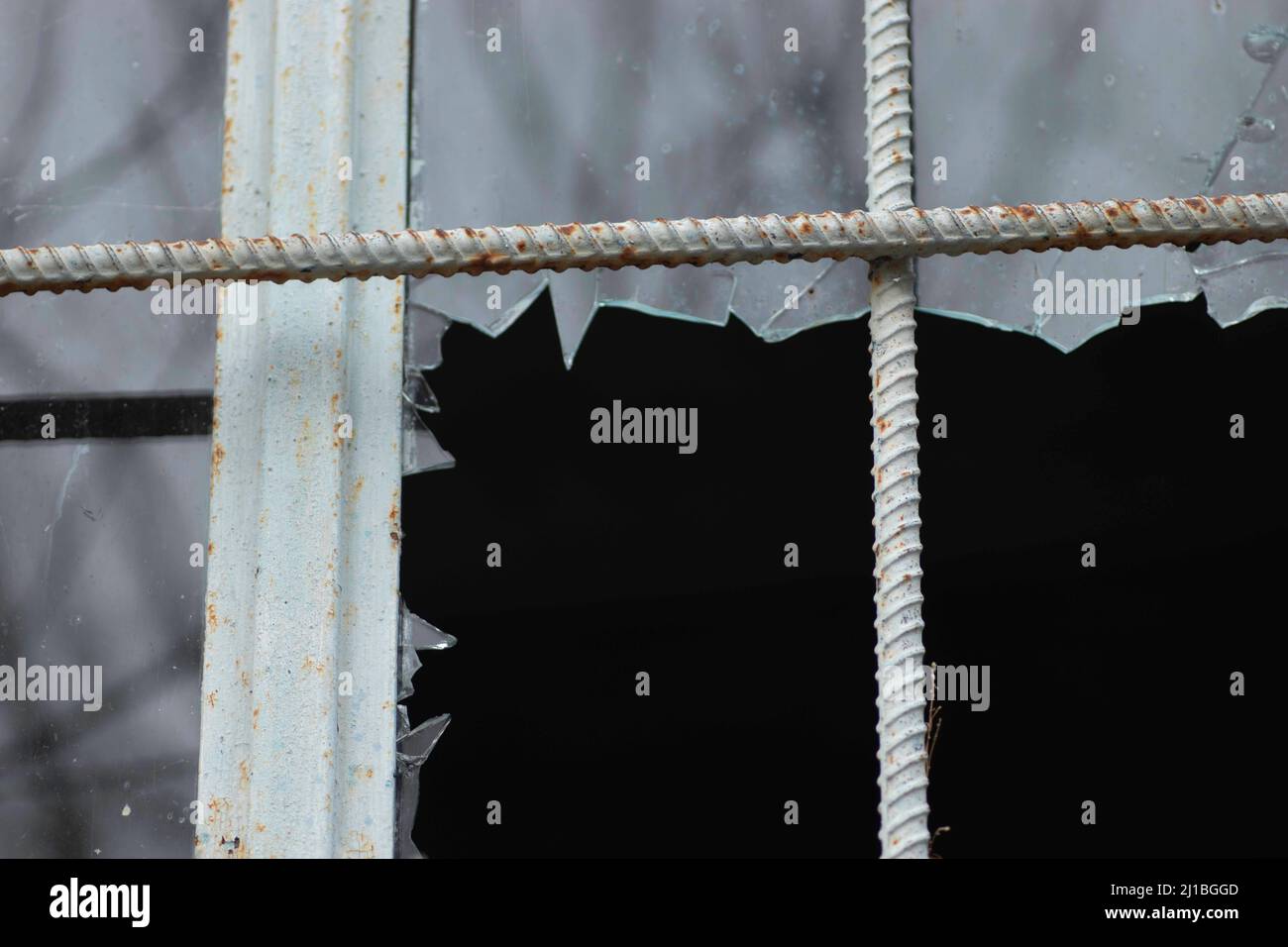 old broken window and white metal grill with rust Stock Photo - Alamy
