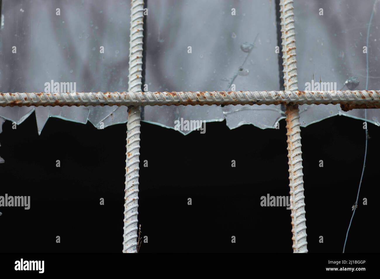 old broken window and white metal grill with rust Stock Photo - Alamy