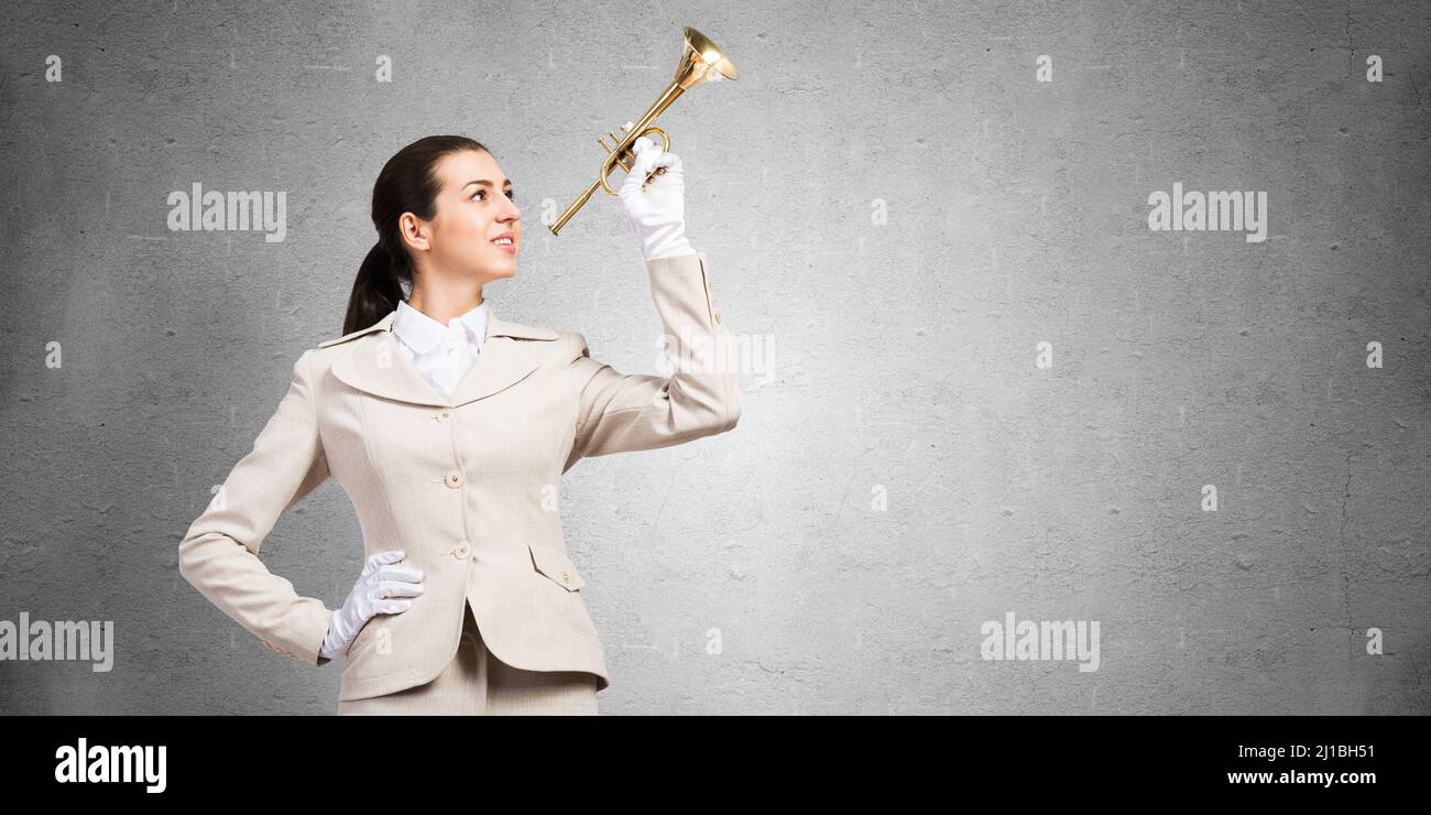 Beautiful woman playing trumpet brass Stock Photo - Alamy