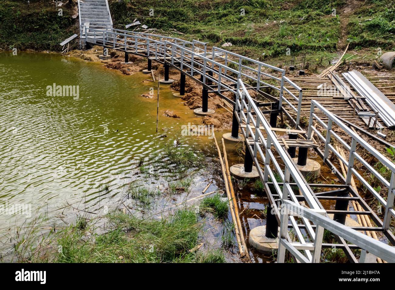 Construction of pedestrian bridge along the reservoir. The structure of ...