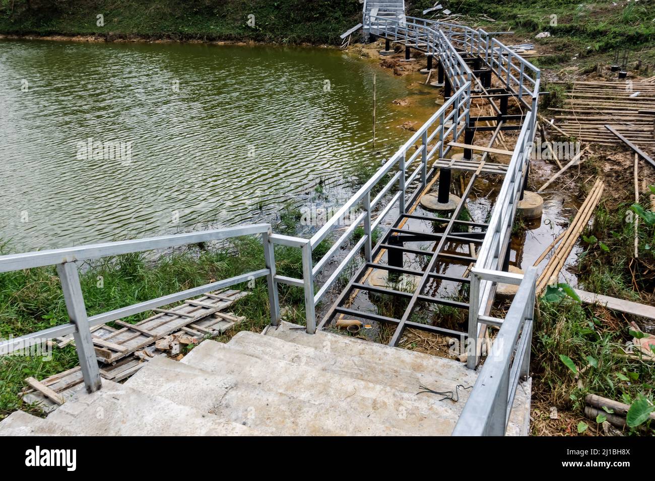 Construction of pedestrian bridge along the reservoir. The structure of ...
