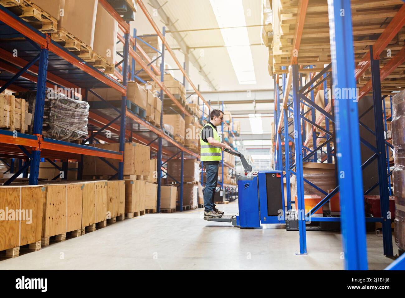 Storehouse employee in uniform working on forklift in modern automatic ...