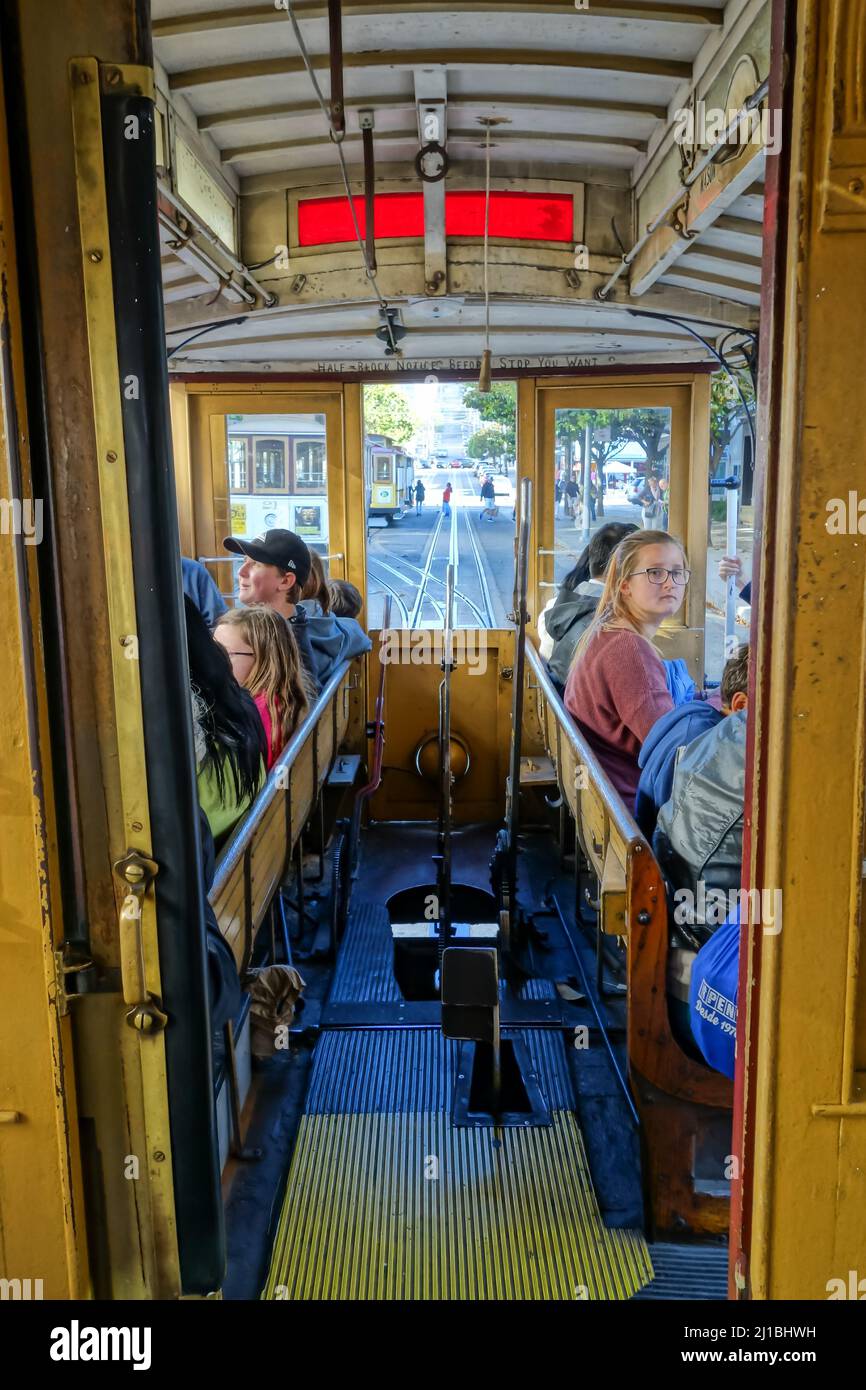 An interior view. of people sitting inside a Street car in San ...
