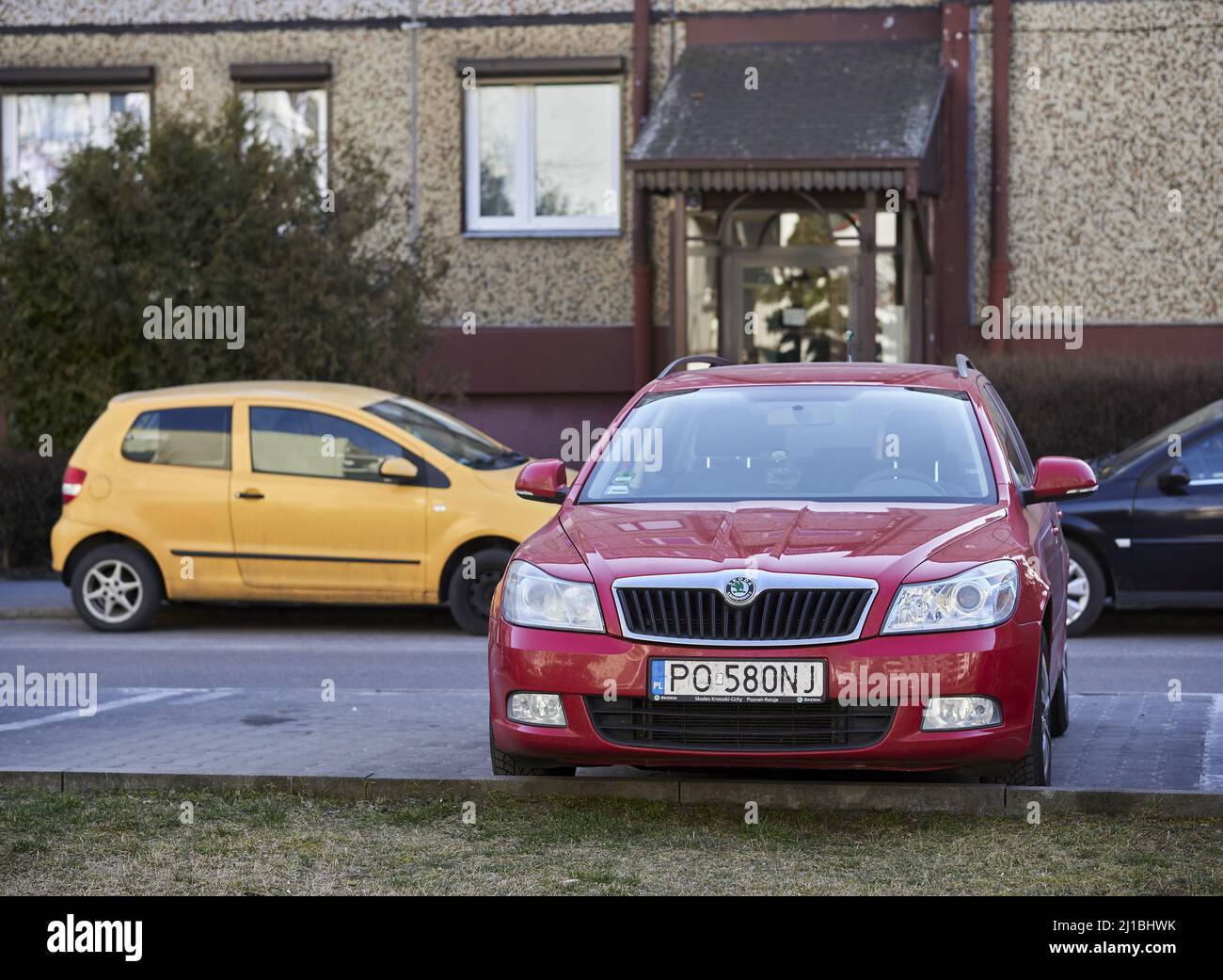 A parked red Skoda brand car in the Stare Zegrze district in Poznan ...