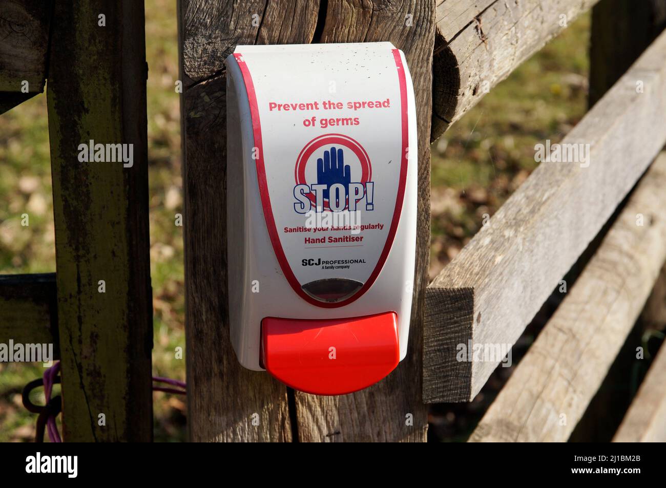 Hand sanitiser dispenser on a wooden gatepost at St Fagans museum ...