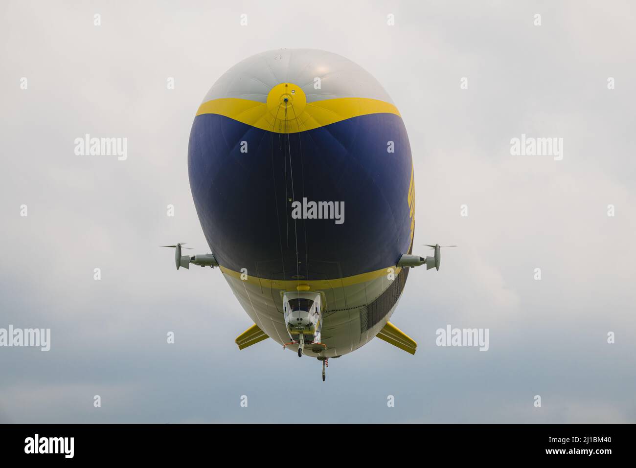 The Goodyear blimp flying in a cloudy sky Stock Photo - Alamy