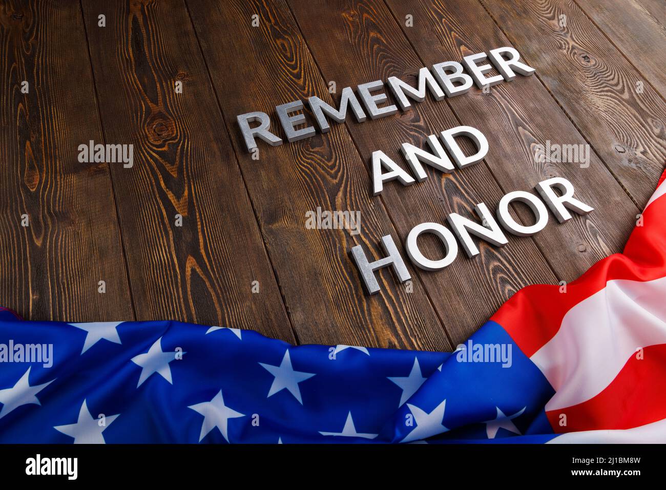 words remember and honor laid with silver metal letters on wooden ...
