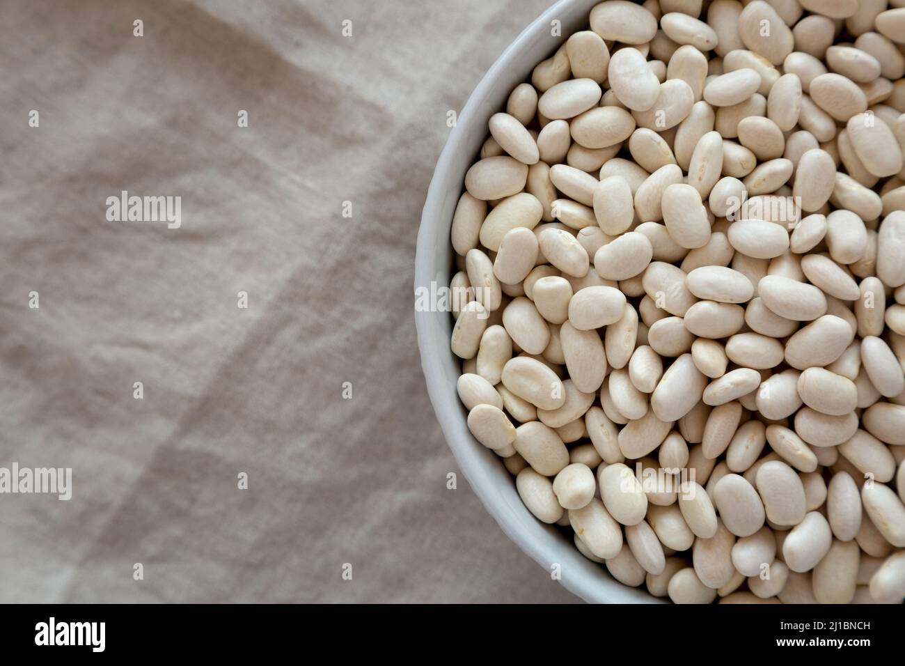 Raw Organic Dry White Beans in a Gray Bowl, top view. Flat lay ...